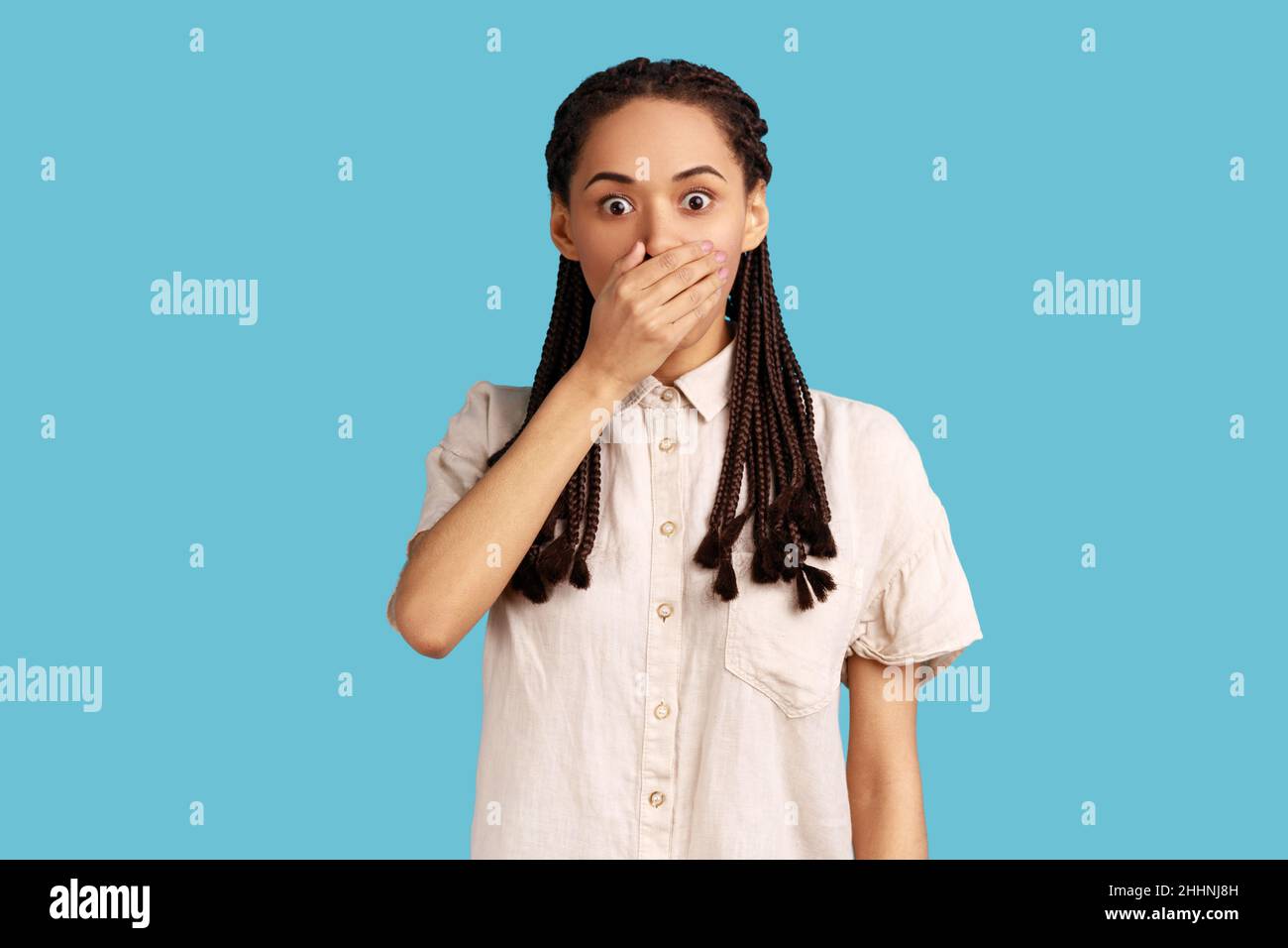 Worried beautiful woman with dreadlocks wants to scream, covers mouth ...