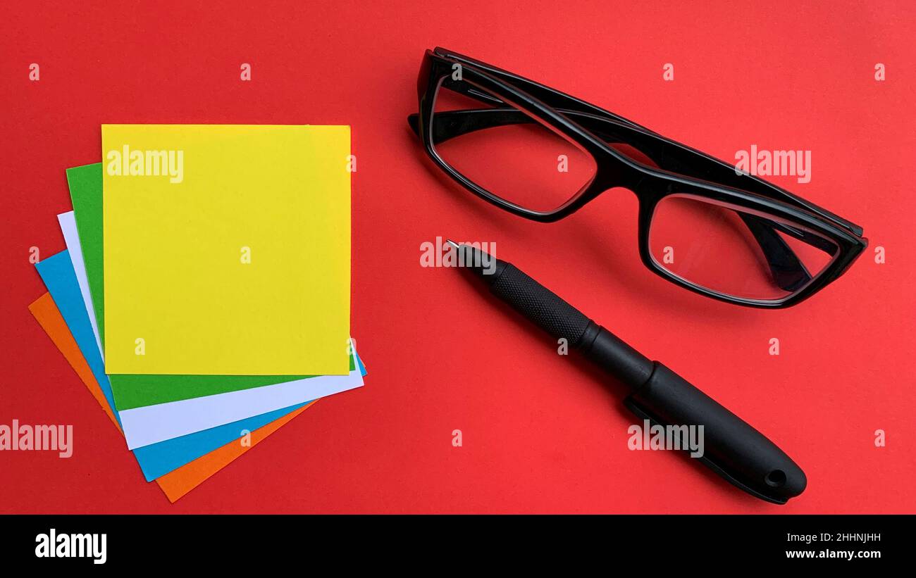 Top view copy space of yellow and colorful notepad with glasses, pen ...