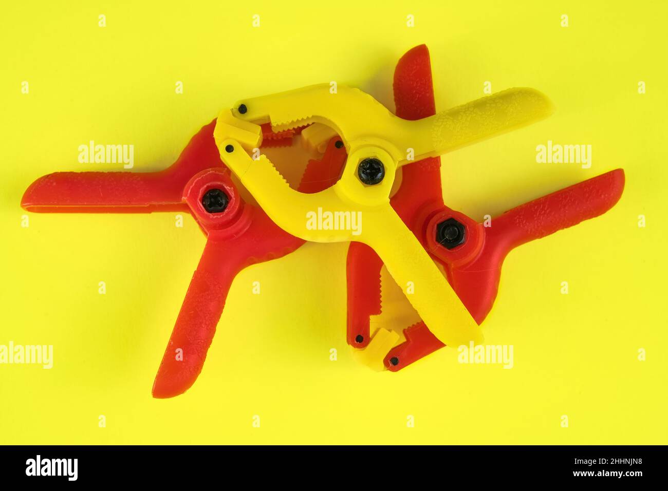 Yellow and red plastic clips over a solid color background Stock Photo ...