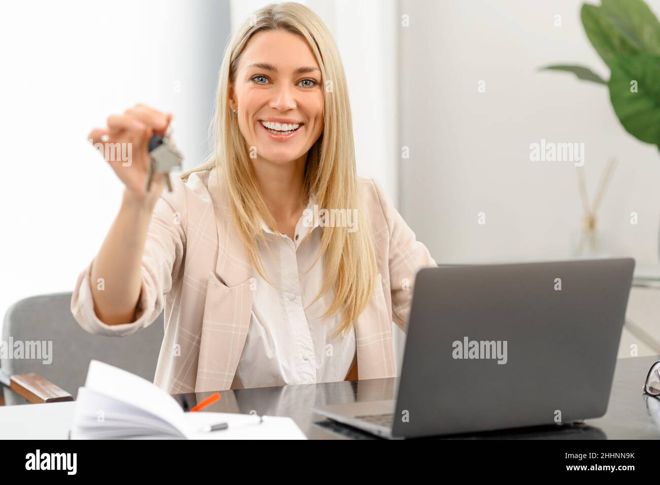 Happy excited caucasian woman holding keys in hand, overjoyed with ...