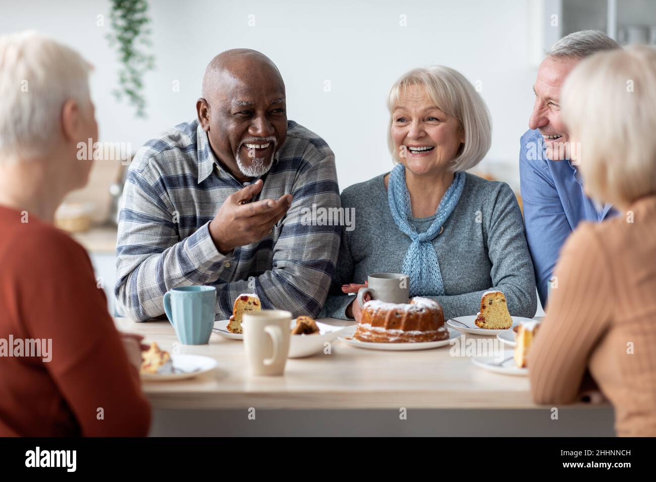International group of positive elderly people drinking tea with cake ...