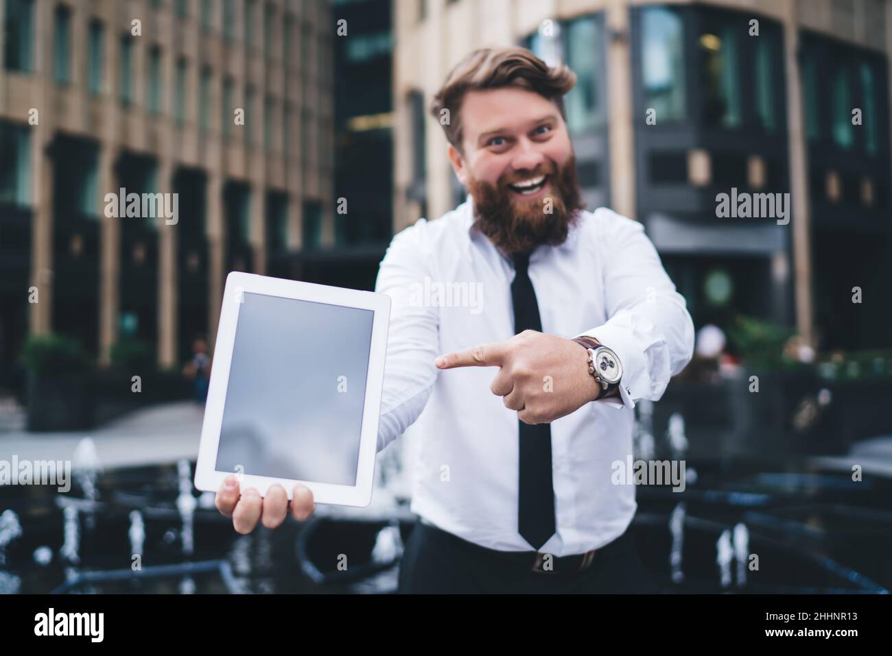 Excited man pointing at screen of tablet Stock Photo - Alamy