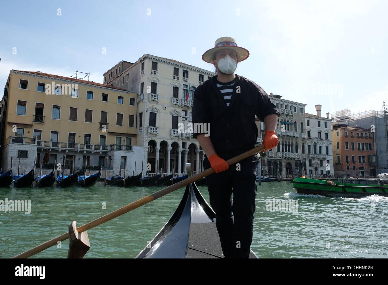 gondolier is rowing during a ferry in the grand canal in venice, Italy ...
