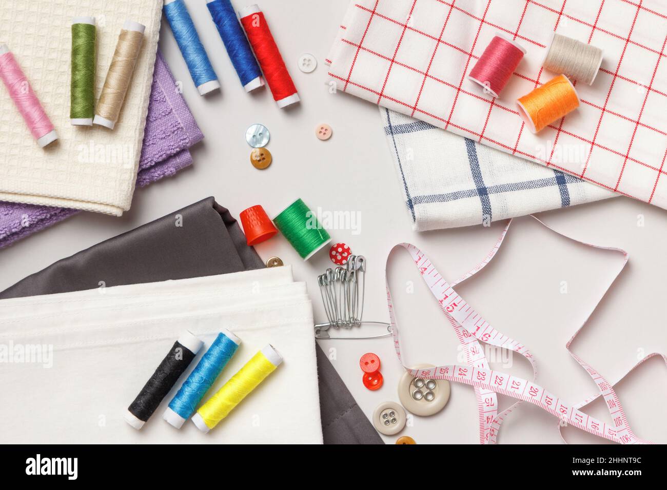 Fabric and threads on a gray background.Sewing tools and accessories ...
