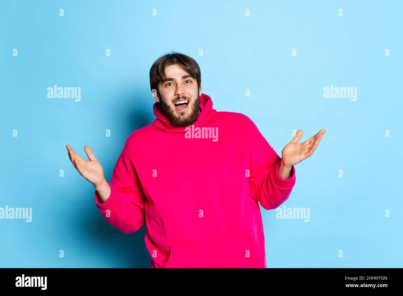Cropped portrait of young man showing emotion of cheerful ...