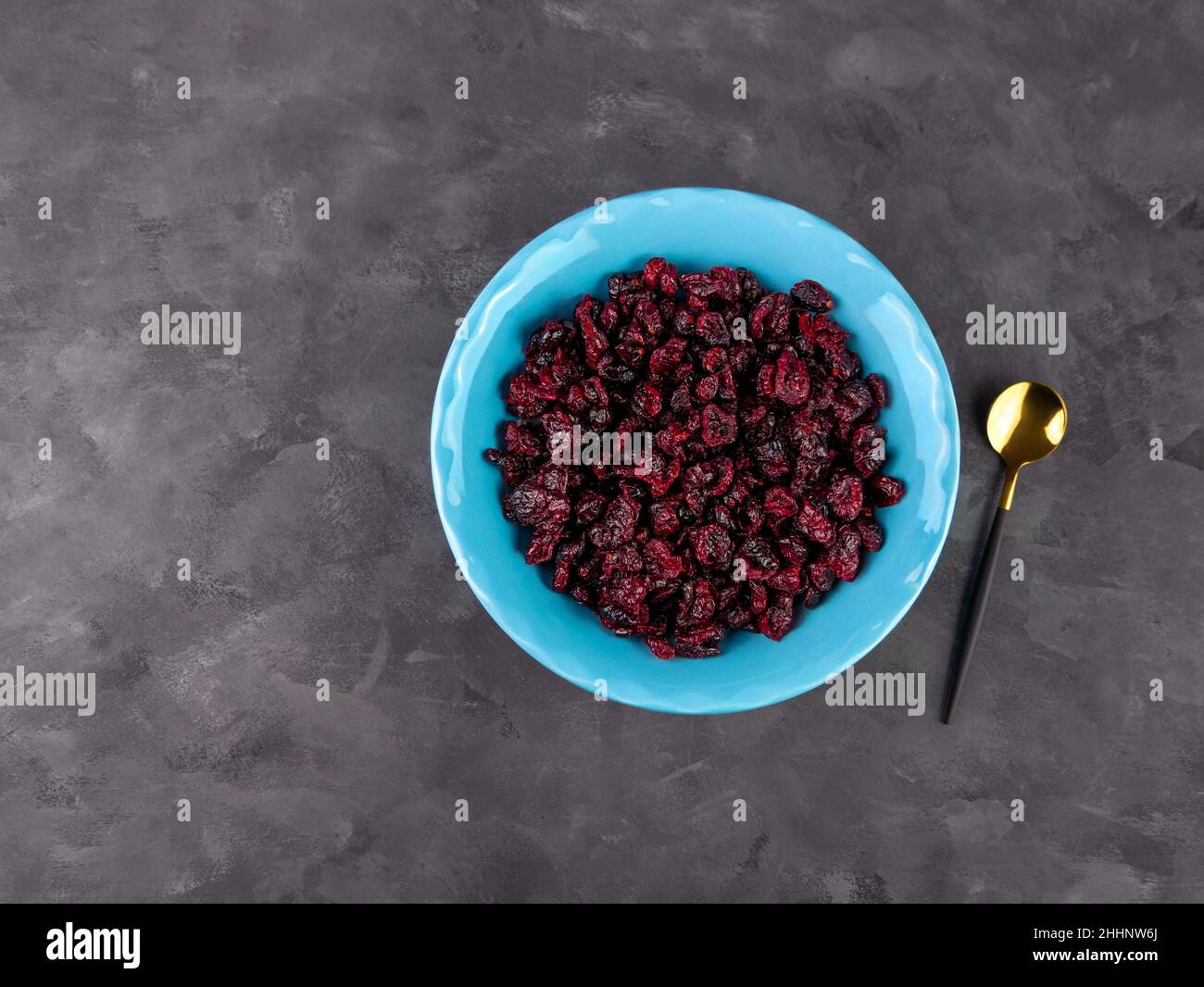 Dried cranberries in blue bowl top view. Healthy tasty dry red berries ...