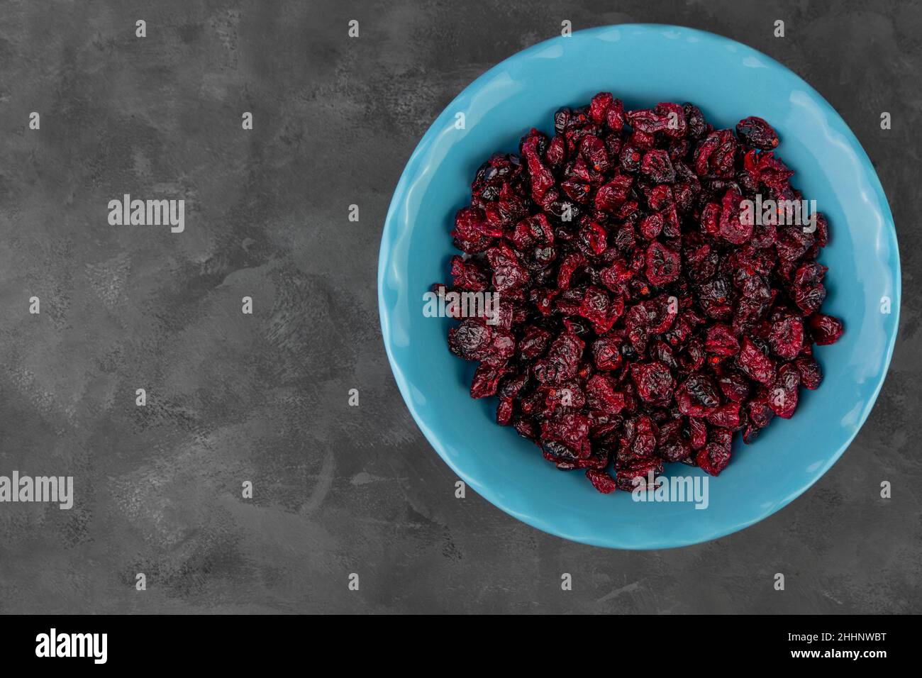 Dried cranberries in blue bowl top view. Healthy tasty dry red berries ...