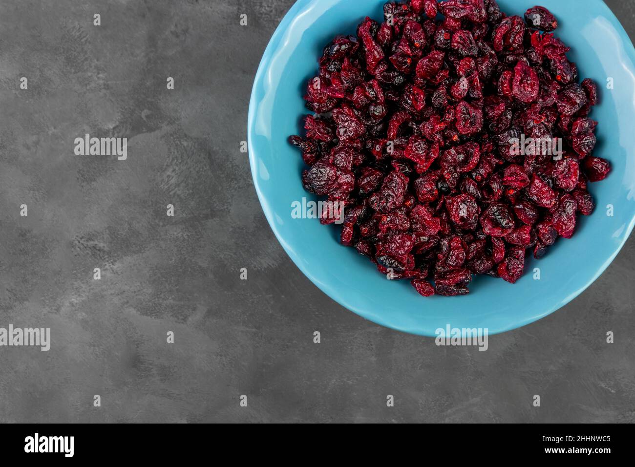 Dried cranberries in blue bowl top view. Healthy tasty dry red berries ...