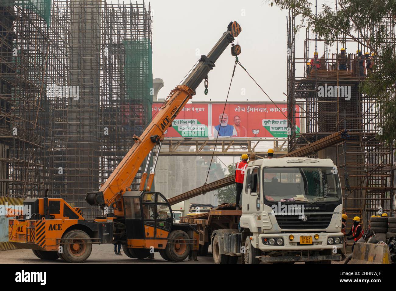 Ghaziabad, India. 25th Jan, 2022. A crane is seen unloading steel rods ...