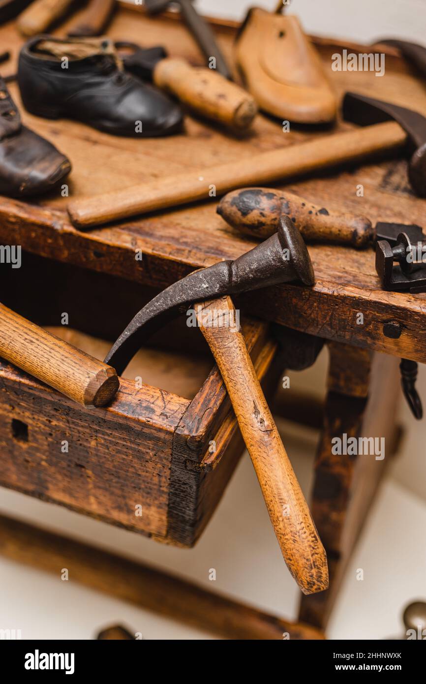 Vertical shot of different tools of a cobbler workplace Stock Photo - Alamy