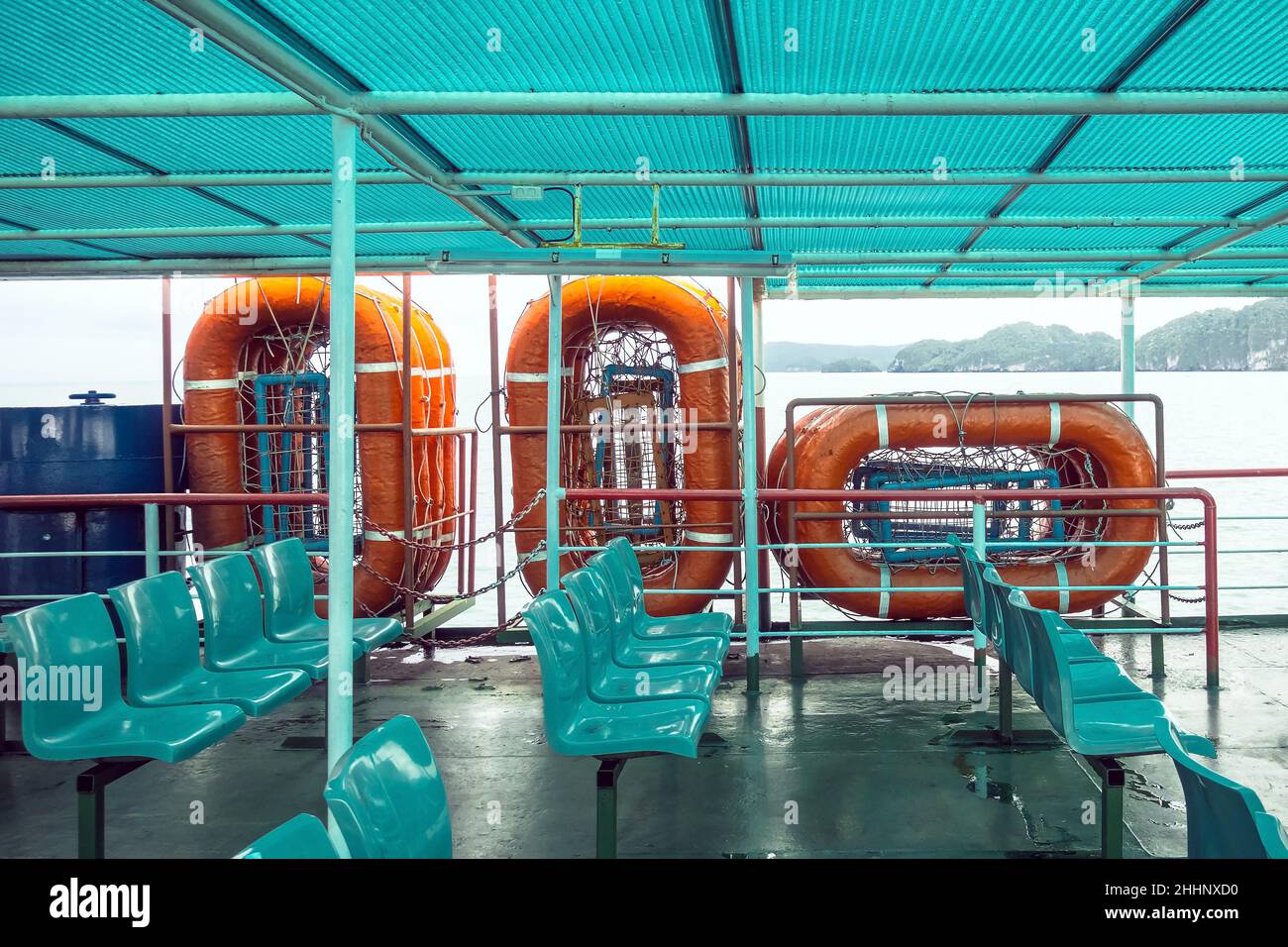 Orange inflatable lifeboats on ferry deck for emergencies and maritime ...