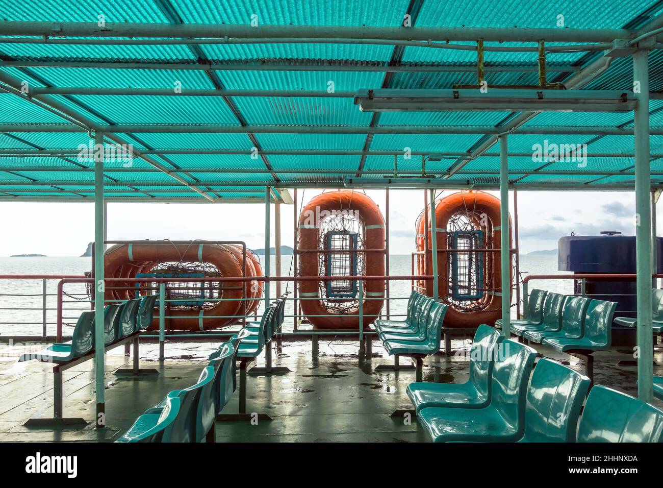 Orange inflatable lifeboats on ferry deck for emergencies and maritime ...