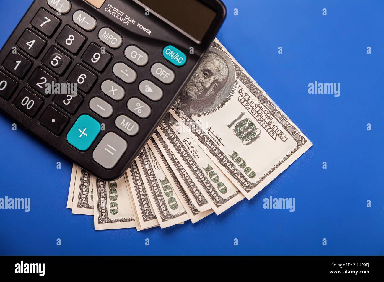 Money and calculator calculation. USD banknotes and a calculator ...