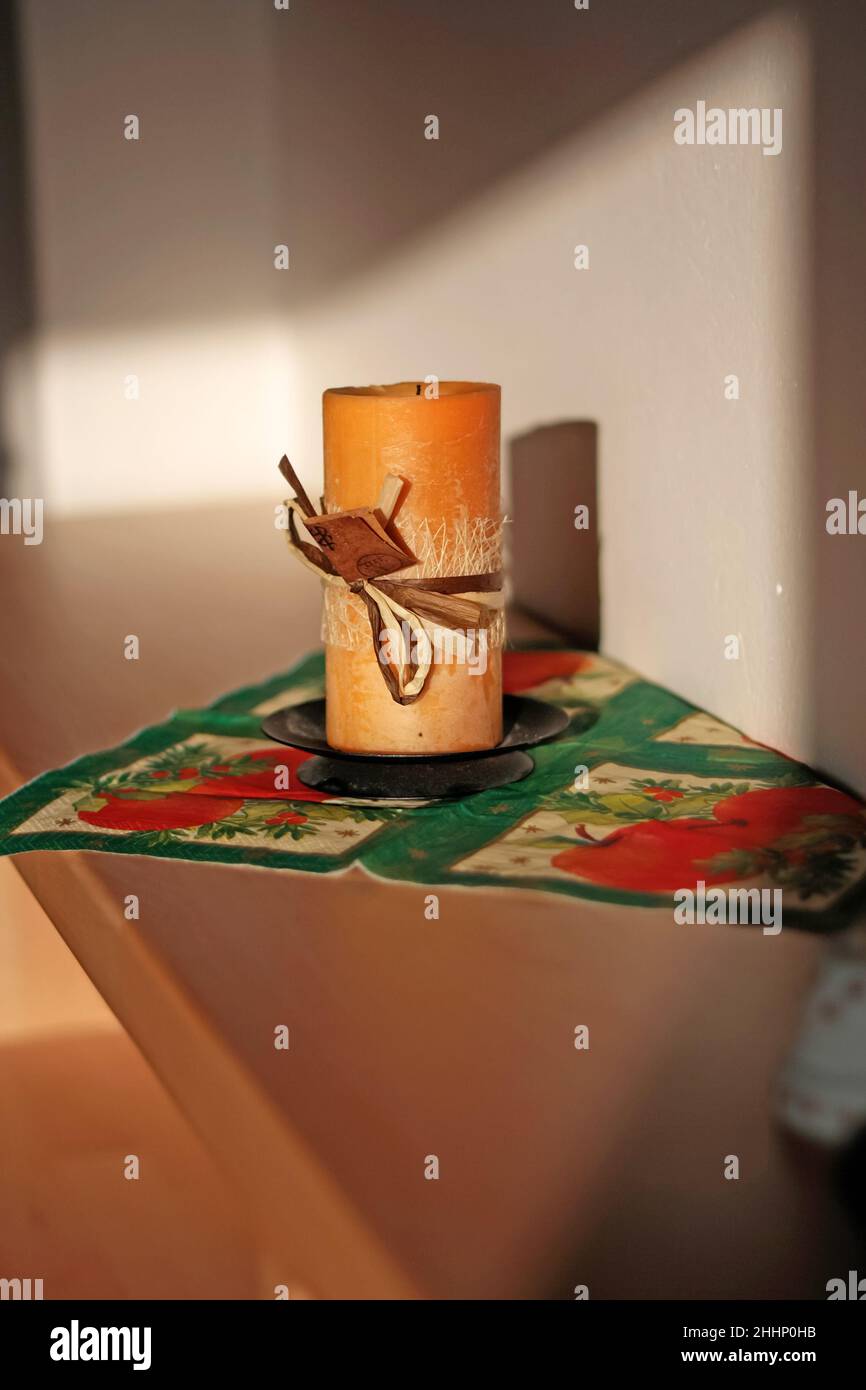 candle on the shelf by the wall Stock Photo - Alamy