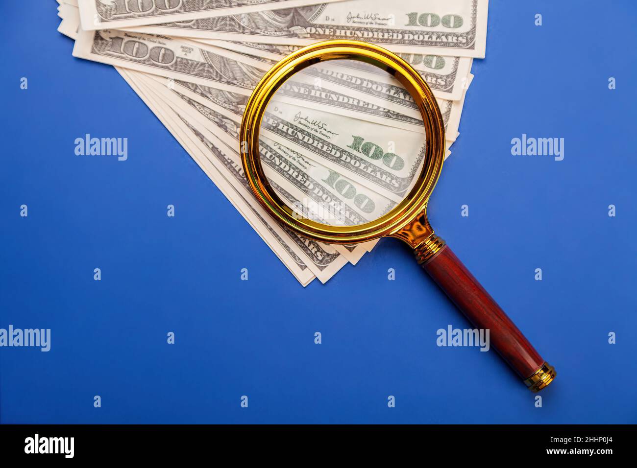 Money with a magnifying glass. Tax, return search or financial report ...