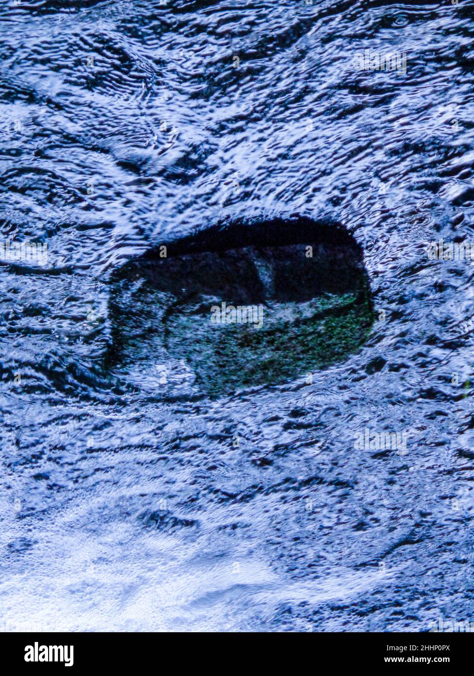 Close-up semi-abstract intimate still life of water swirling about a ...