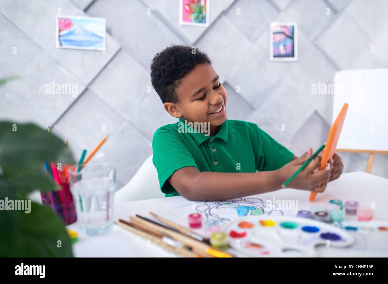 African american boy holding pencil hi-res stock photography and images - Alamy