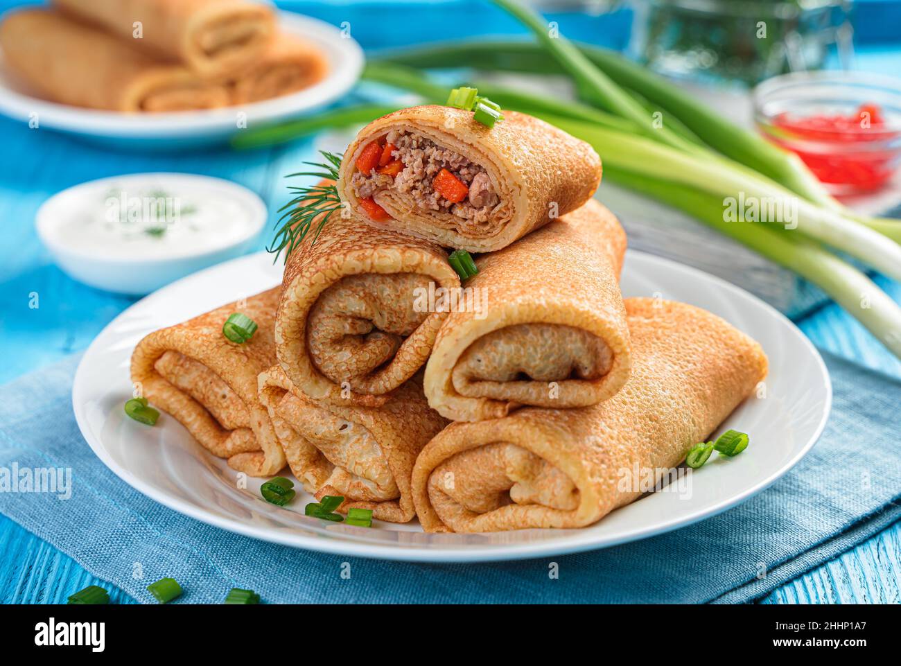 Thin fried pancakes stuffed with minced meat with carrots and decorated ...