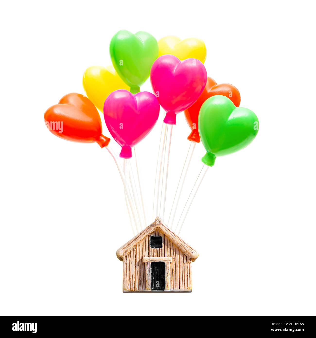 Miniature wooden house with a cluster of multicolored heart shaped ...