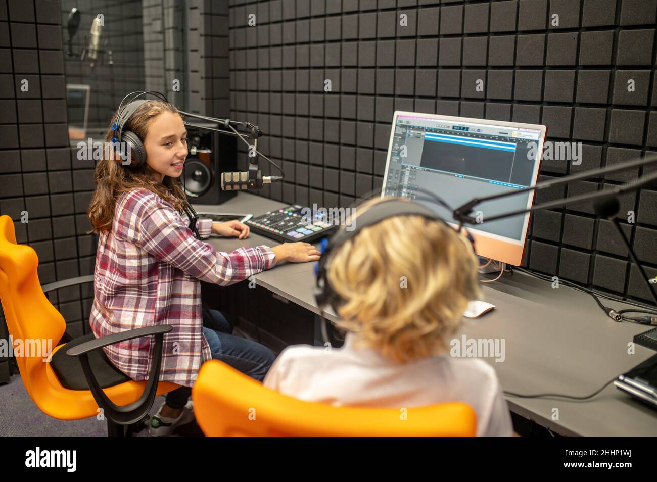 Two children in headphones recording a podcast Stock Photo - Alamy
