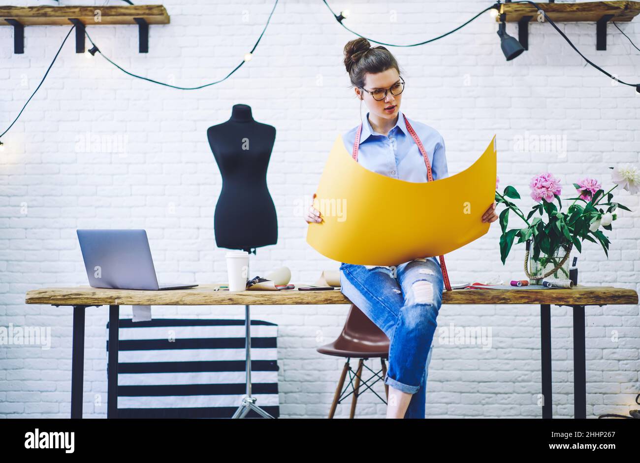 Thoughtful seamstress looking at sewing pattern Stock Photo - Alamy