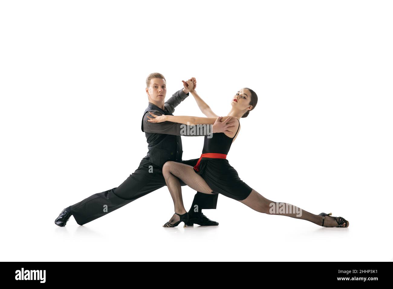Grace and beautiful dancers, young couple dancing Argentine tango isolated on white studio ...