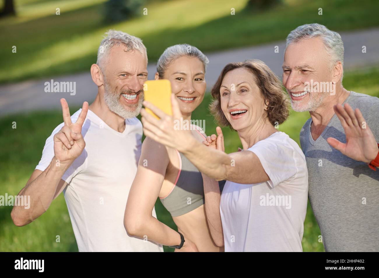 Group of mid aged people making selfie Stock Photo - Alamy