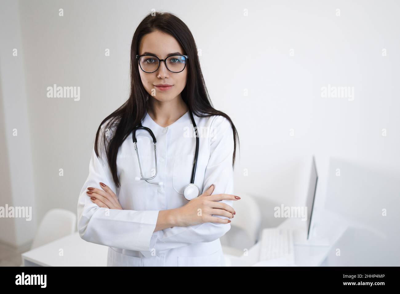 Confident female medical worker with arms crossed Stock Photo - Alamy