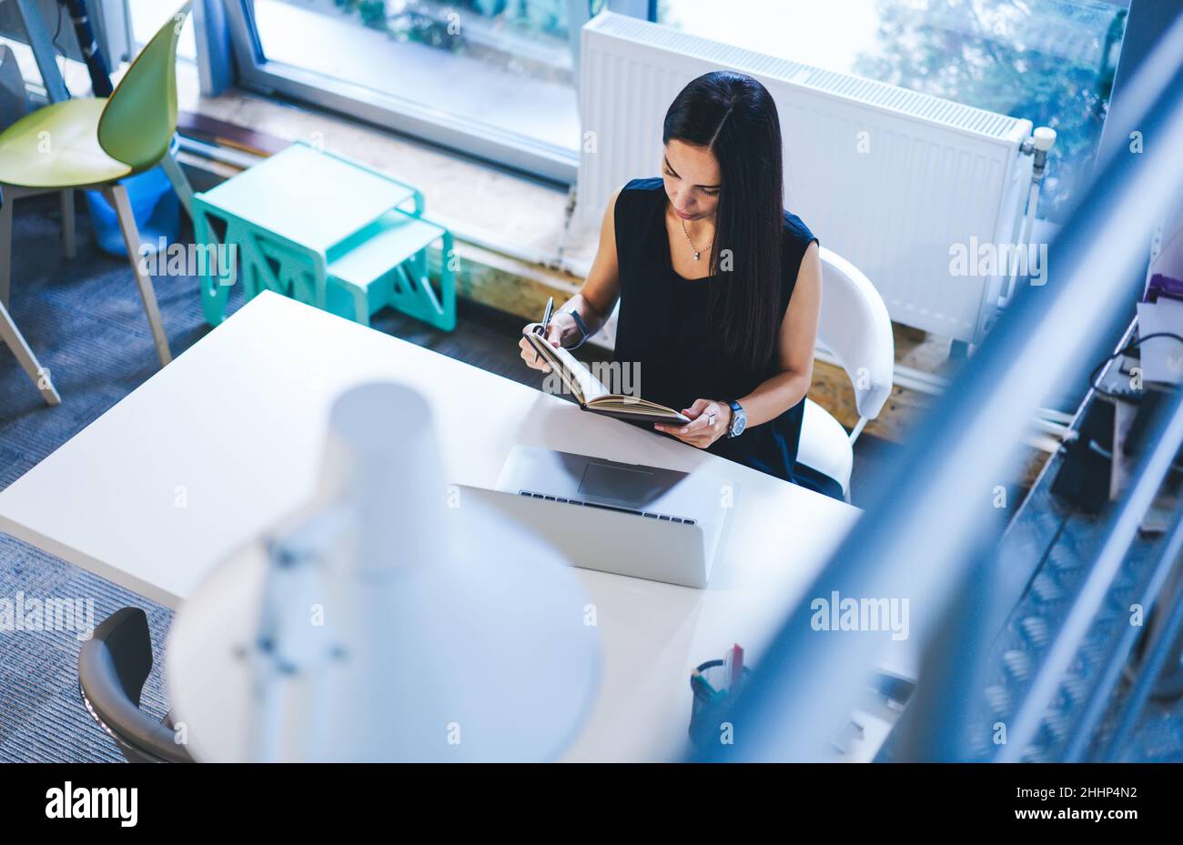 Focused woman reading notes while working in office Stock Photo - Alamy