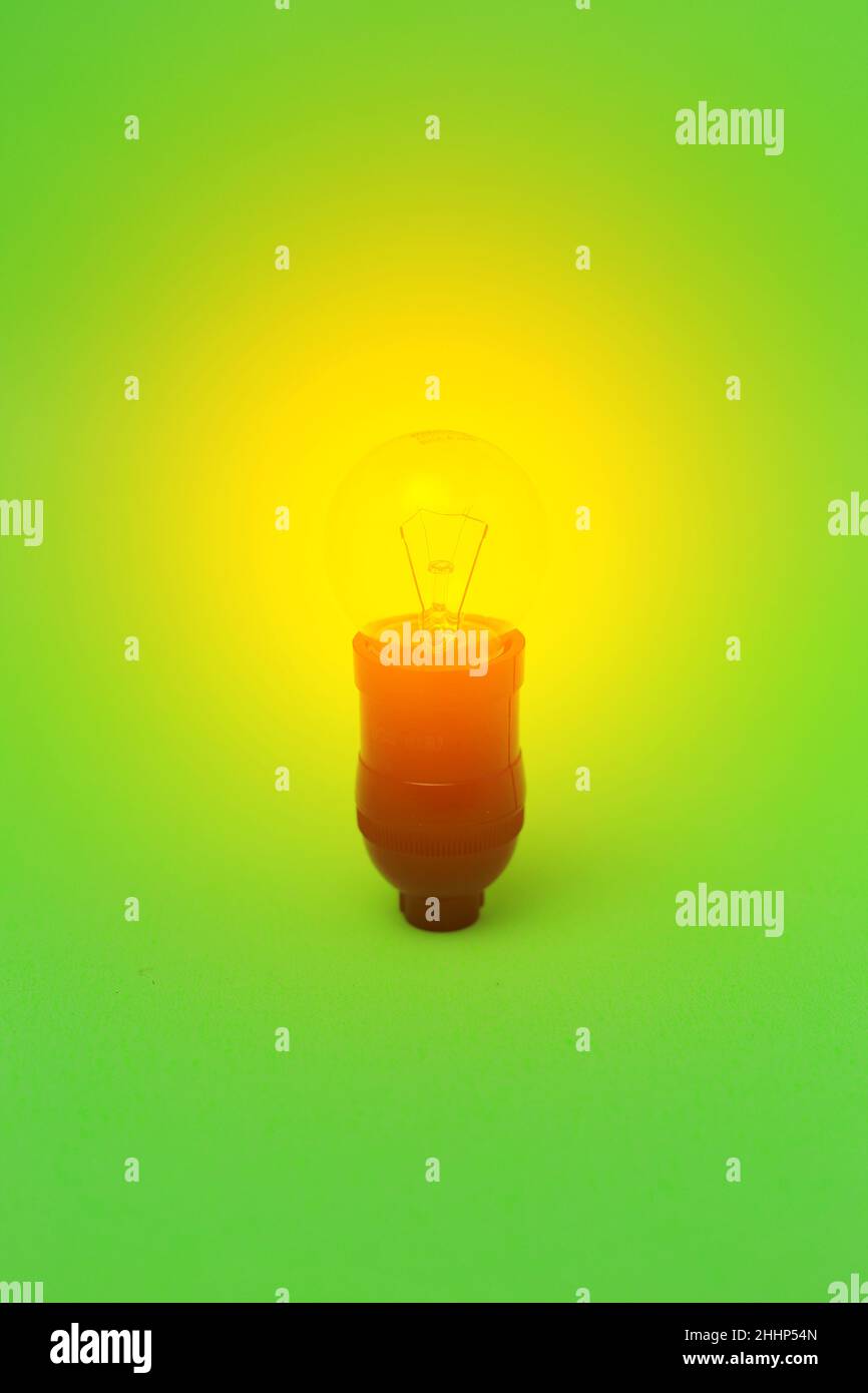 Light bulb on green background, lighting concept in life Stock Photo ...