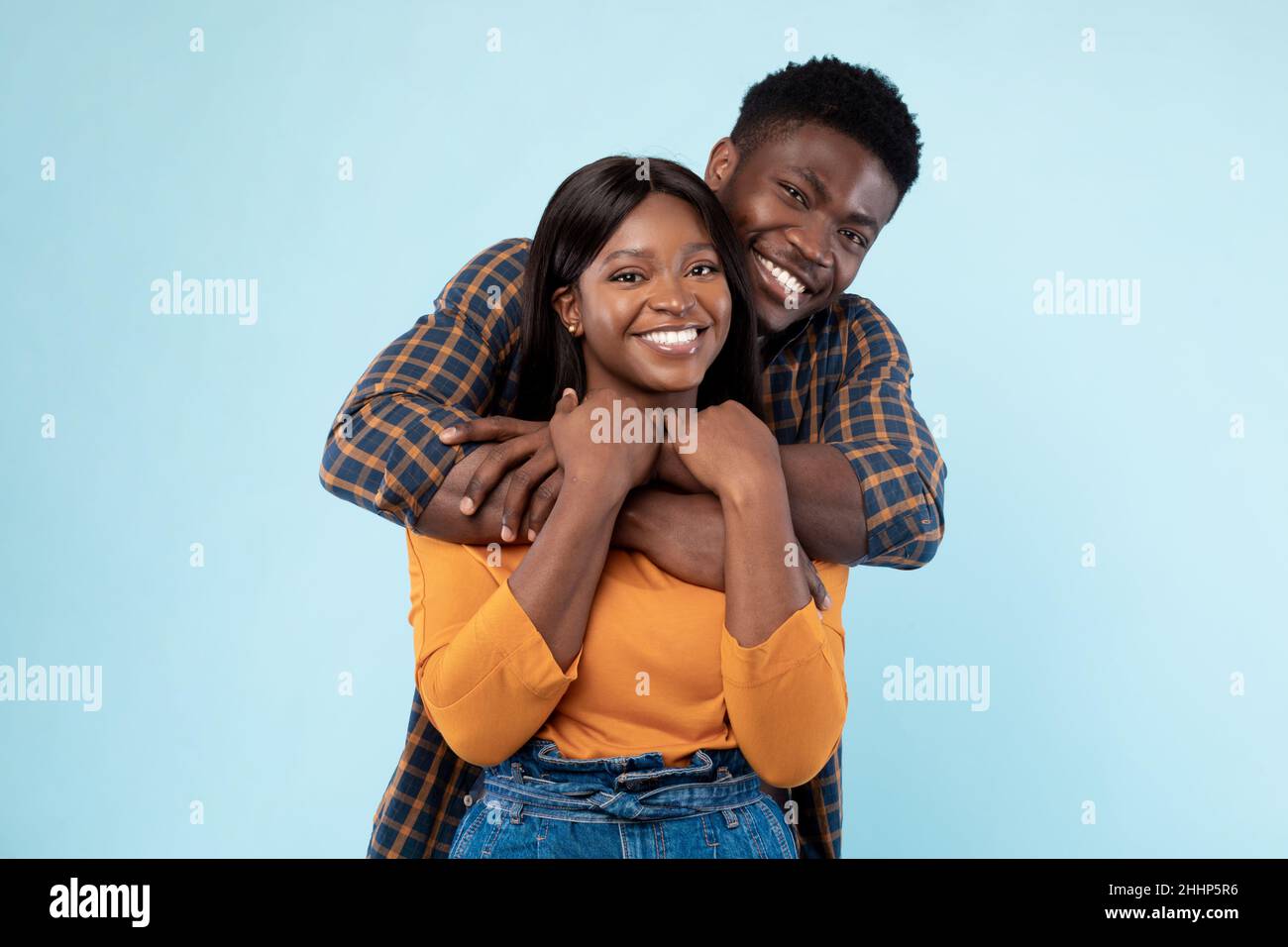 African American lady cuddling with her happy man Stock Photo - Alamy