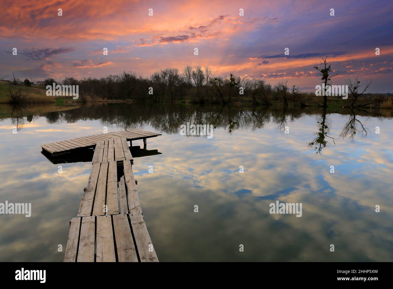 quiet landscape with sunset landscape with wooden fishing bridge on ...
