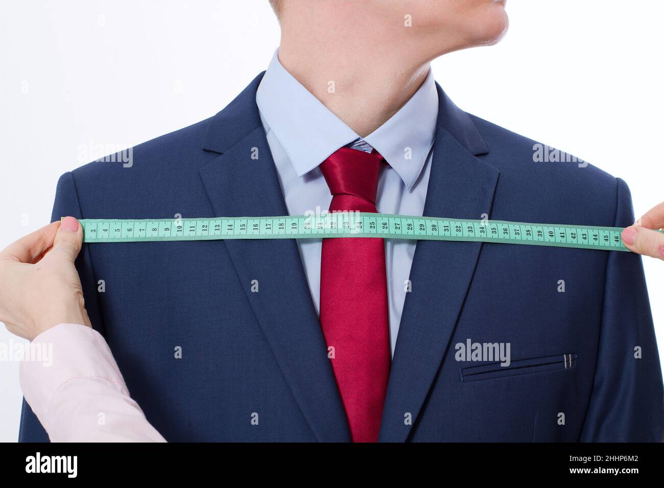 Closeup image of tailor taking measurements for business jacket suit ...