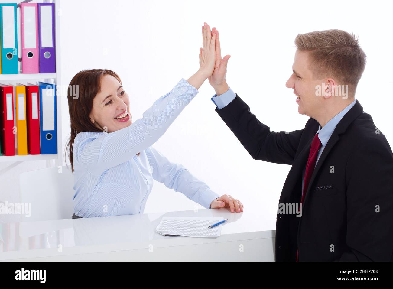 Businesswoman and businessman giving high-five for good job at office ...
