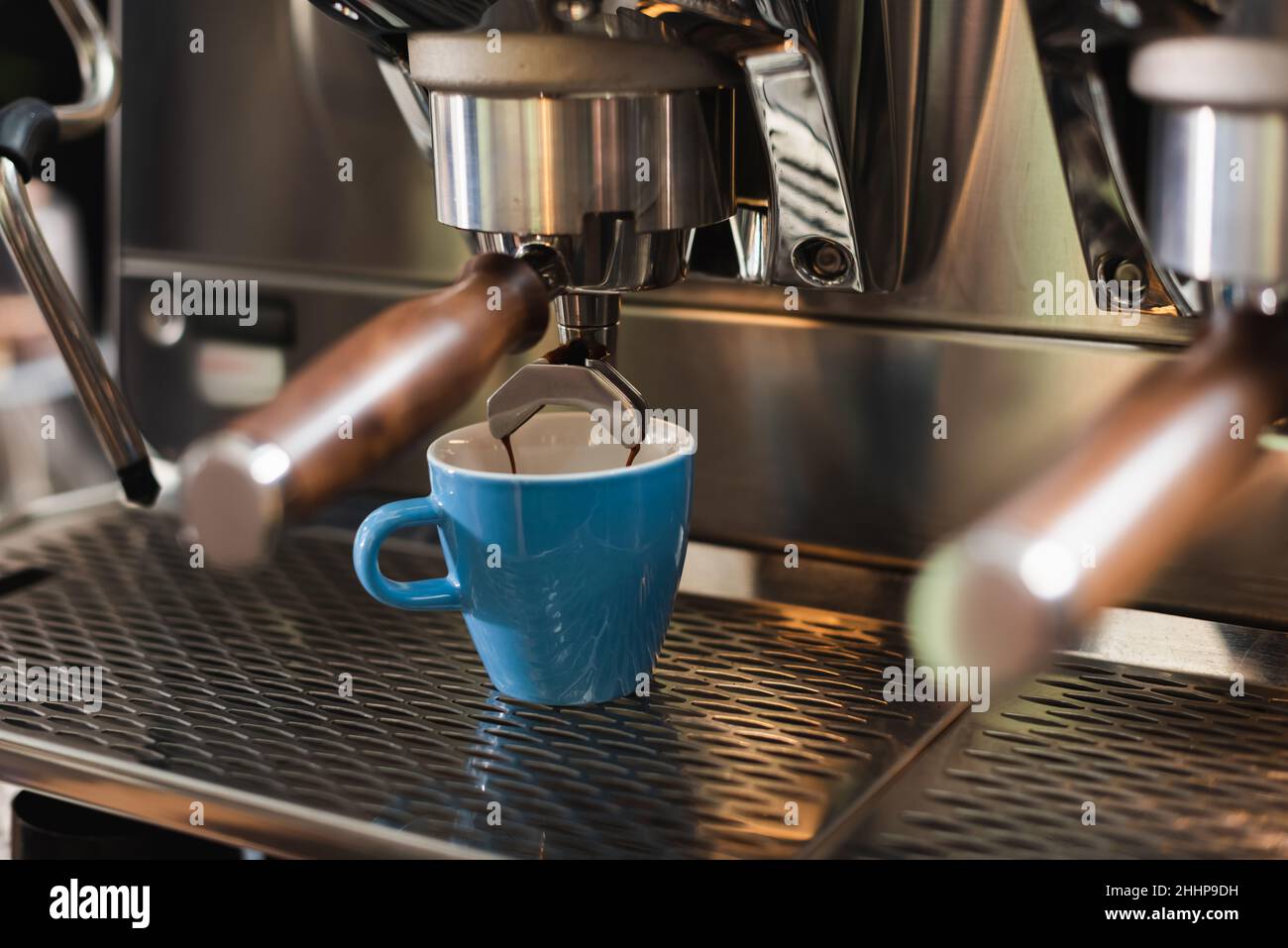 Cup near portafilter of coffee machine in cafe Stock Photo - Alamy