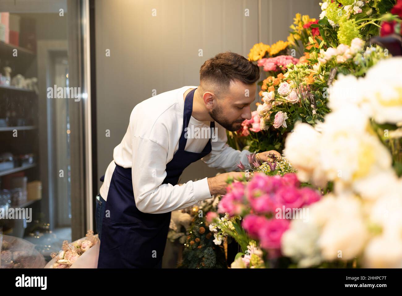 the florist takes fresh flowers in the flower shop in the fridge Stock ...