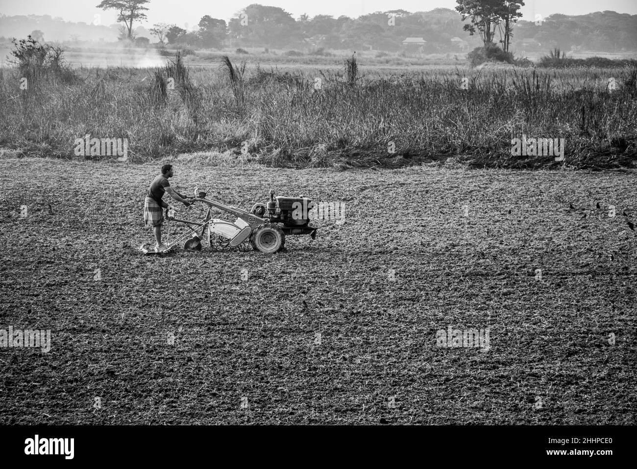 Farmer cultivating field with tractor in winter seasons. I captured ...