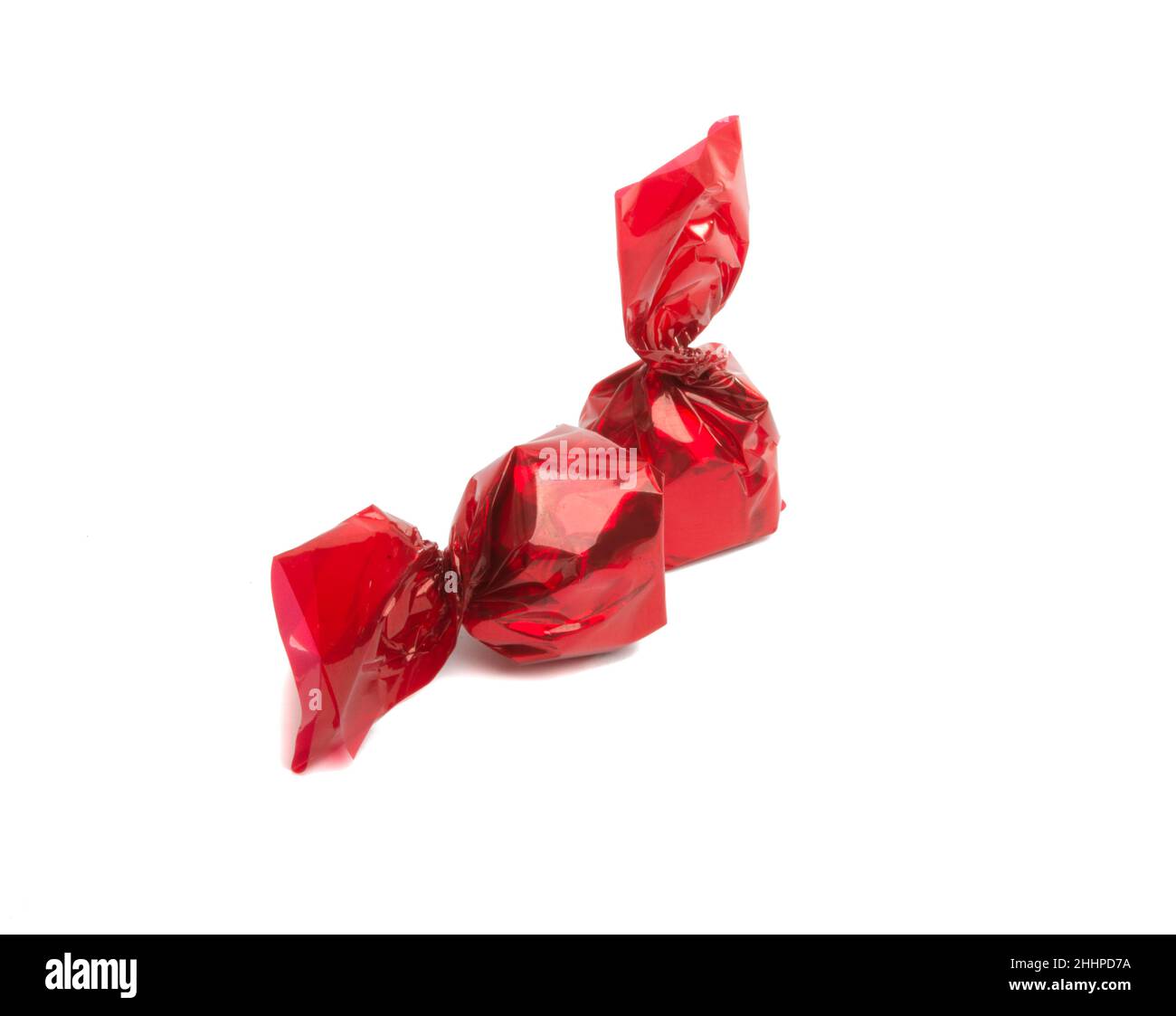 Sweets in red foil isolated Stock Photo - Alamy