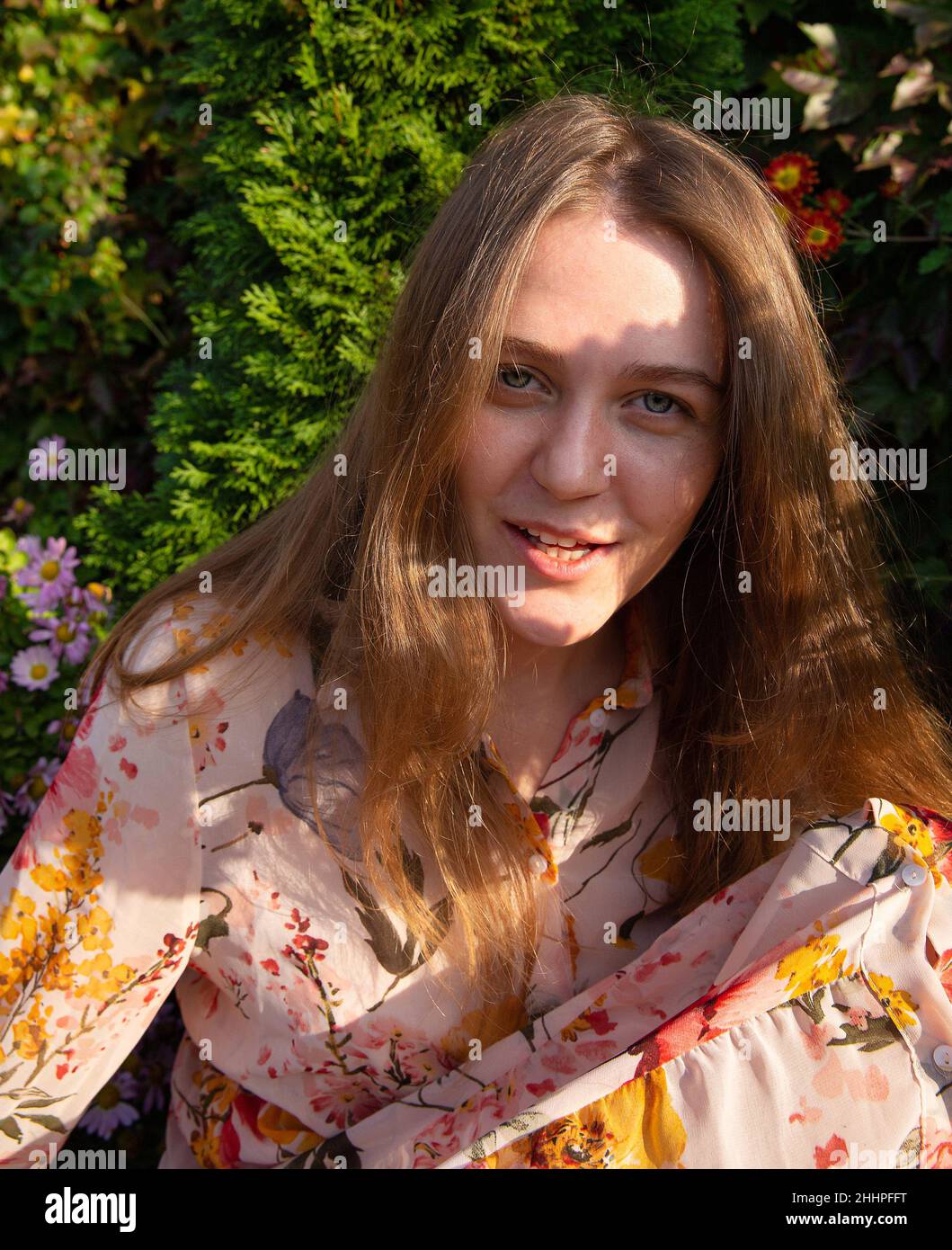 Young woman with white skin with greenery behind portrait with shadow ...