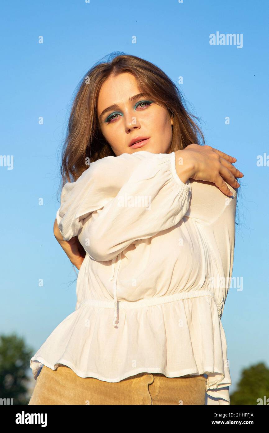 Woman hugging herself outdoors hi-res stock photography and images - Alamy
