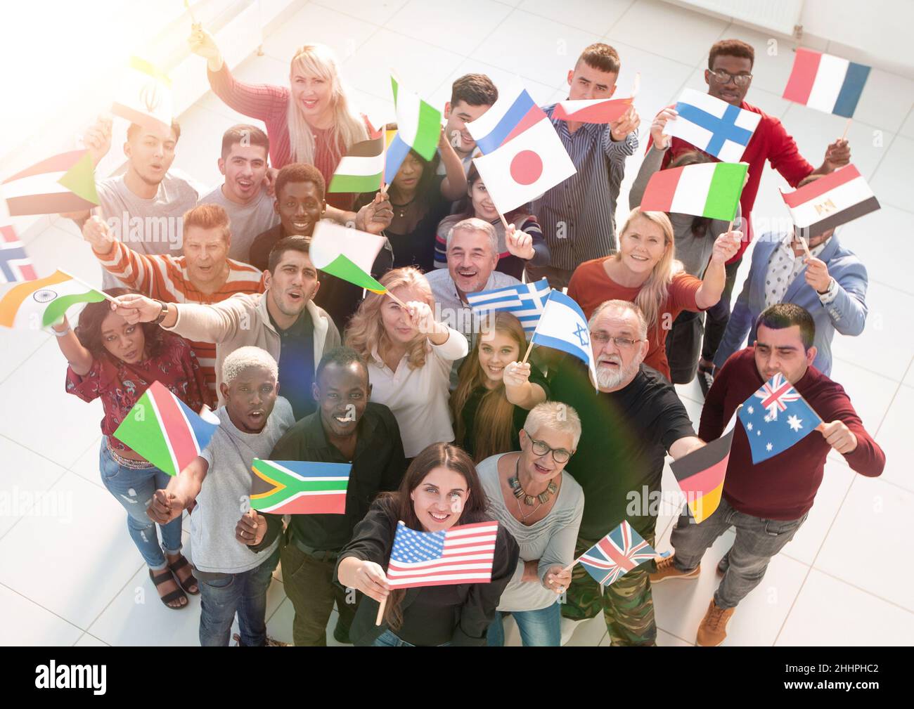 group of people with international flags looking up Stock Photo - Alamy