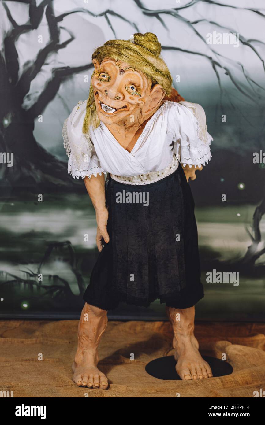 Vertical closeup of a sculpture of an old witch that stole children ...