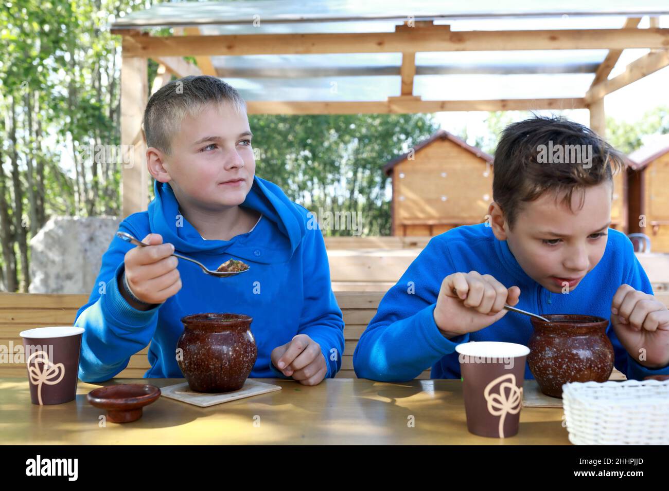 Two boys eating pot roast in restaurant Stock Photo - Alamy