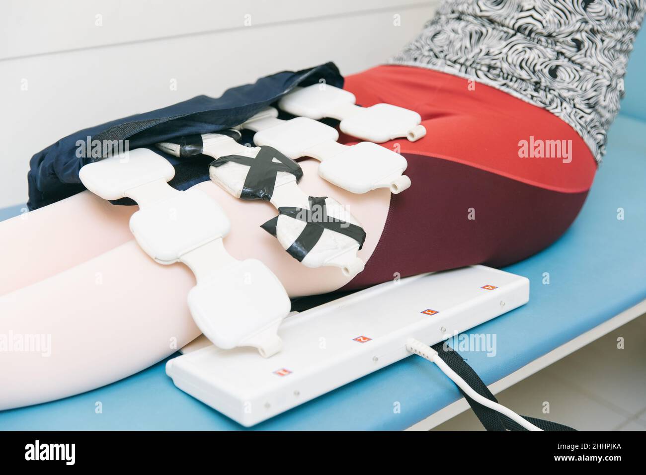 Woman in clinic at the treatment of pressure therapy procedure for legs ...