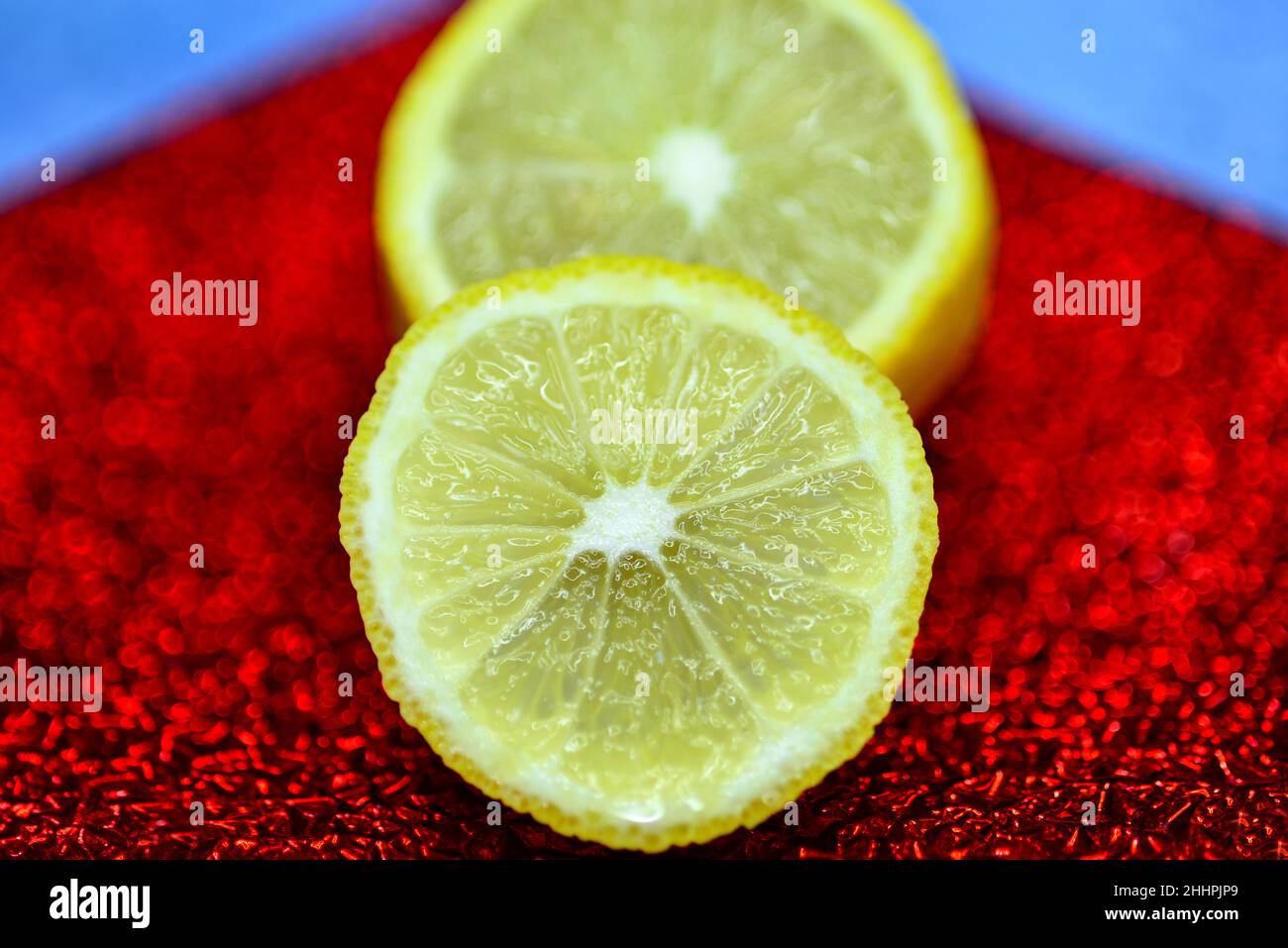 lemon slice on a red shiny enamelled plate Stock Photo - Alamy