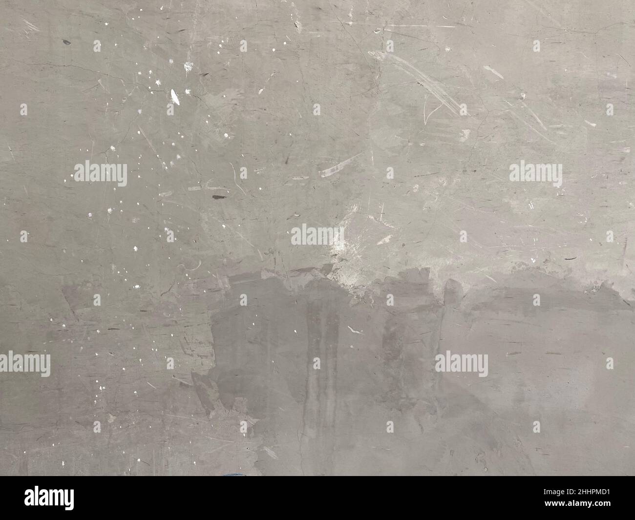 A gray concrete wall texture with paint spots Stock Photo - Alamy