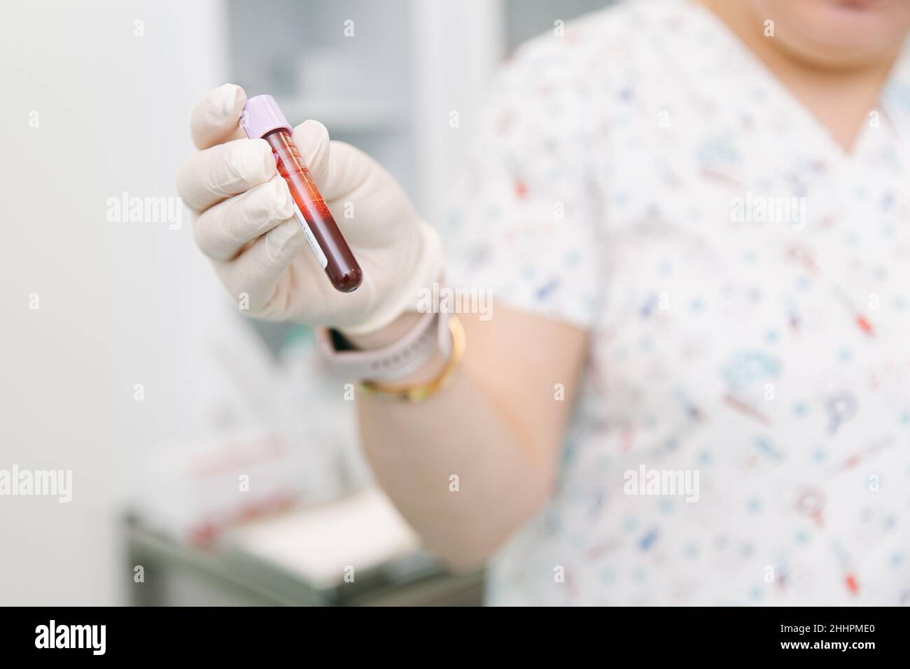 Taking a blood test from a vein in the treatment room. Nurse pricking a ...