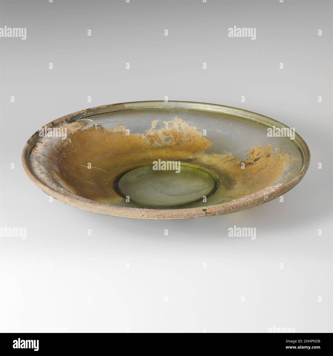 Glass dish 4th century A.D. Roman Translucent green.Tubular, slightly ...