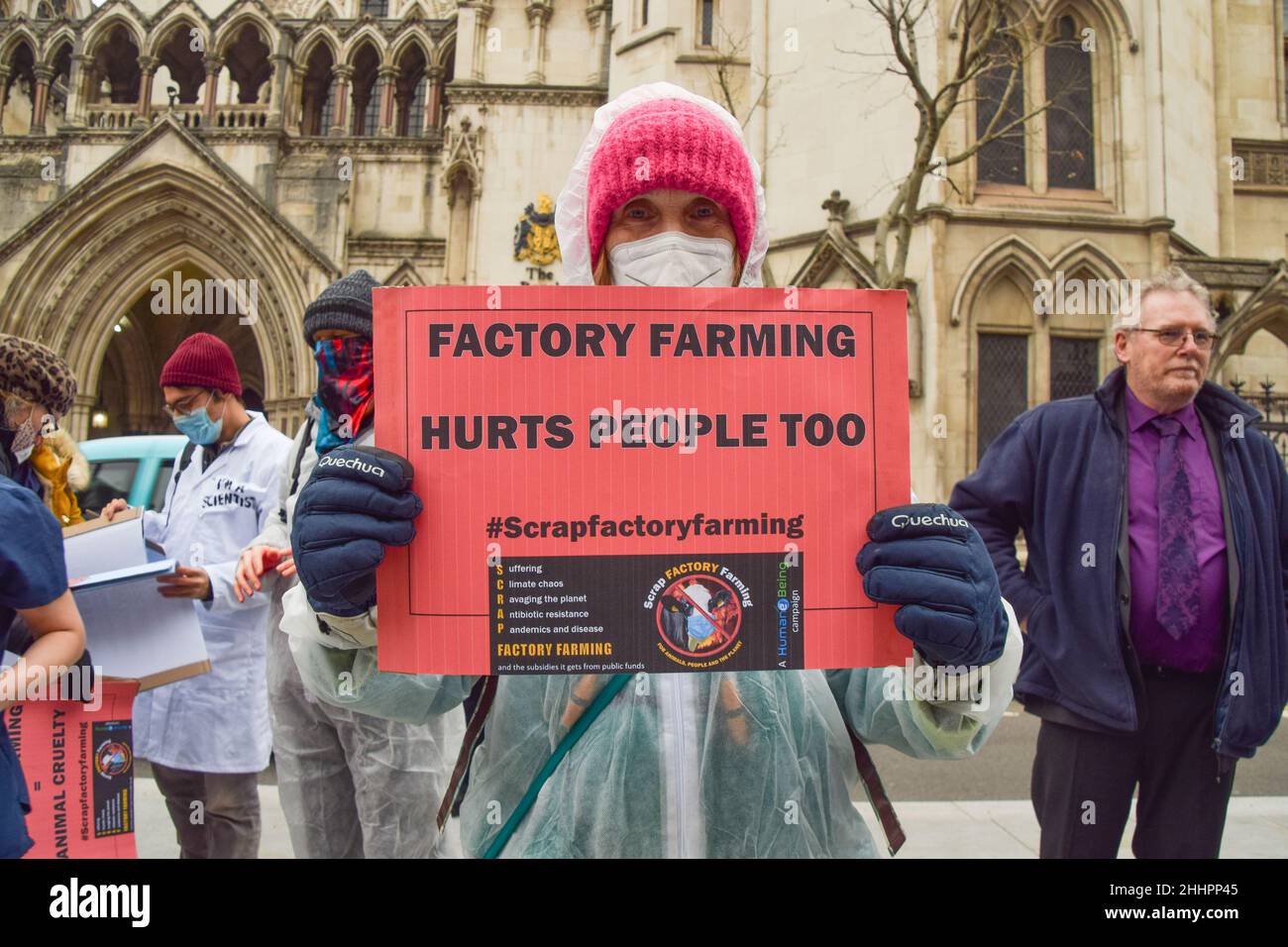 London, UK. 25th Jan, 2022. An activist wearing a hazmat suit holds an ...
