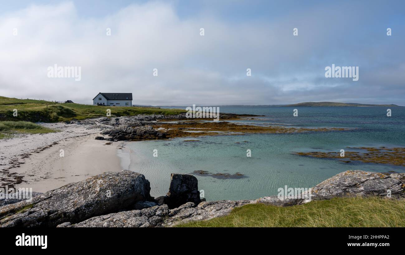 View towards a residential house on Eriskay Beach near the coastal ...